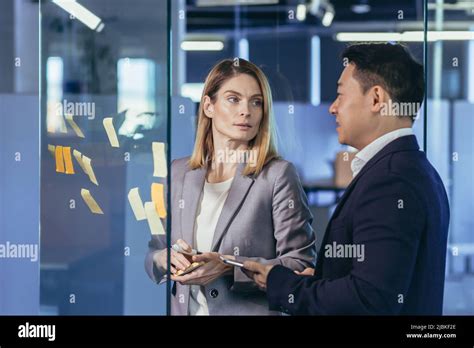 Asian And Female Business People Create And Assign Projects With