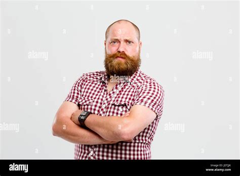 Guy With Screwed Up Eye With Ginger Beard And Mustache On Empty Gray