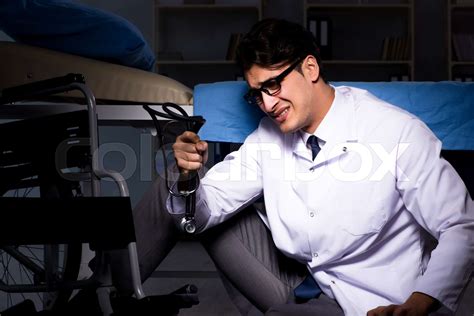 Doctor Working Night Shift In Hospital After Long Hours Stock Image