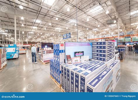 Customer Shopping For Variety Of 4k Uhd Led Lcd Tv On Display At