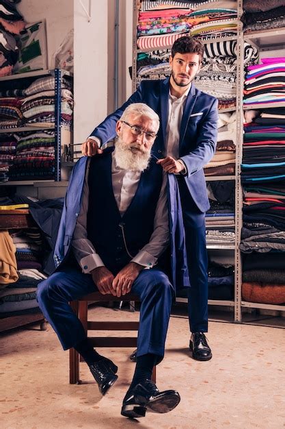 Free Photo Portrait Of A Man Holding Coat Over His Senior Mans Shoulder