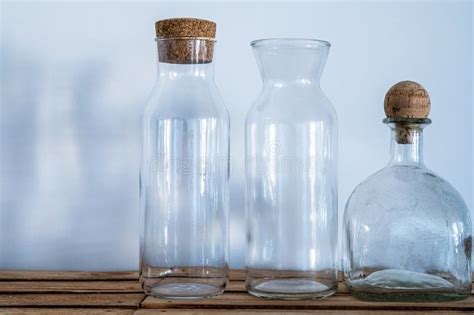 Three Glass Bottles Of Different Shapes On A White Background Empty