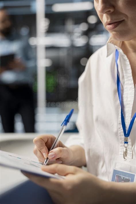 Woman In Data Center Taking Note On Fixes To Be Made After Running