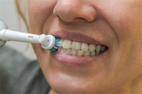 Woman Brushes Her Teeth With An Electric Toothbrush Stock Image Image
