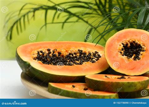 Plate With Fresh Juicy Cut Papayas On White Table Against Blurred