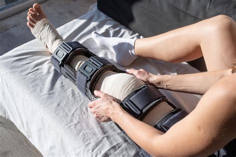 Premium Photo Female Buckling Knee Orthosis Or Knee Support Brace After Surgery On Leg