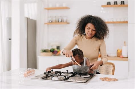 Premium Photo Busy Mom Cooking Food In Kitchen Stove Island At Home