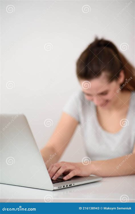 The Girl Is Out Of Focus Sitting At The Computer And Laughing Head Tilted Downwards Stock Image