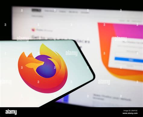 Mobile Phone With Logo Of Open Source Web Browser Mozilla Firefox On Screen In Front Of Website