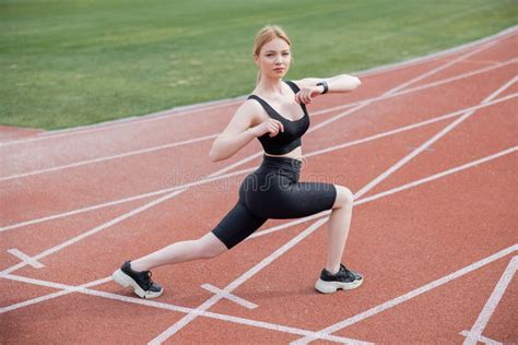 Full Length View Of Young Sportive Woman Exercising On Stadiumstock