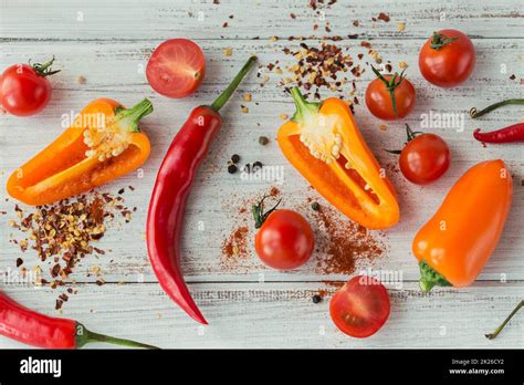 Assorted Peppers Cherry Tomatoes And Spices On Light Background