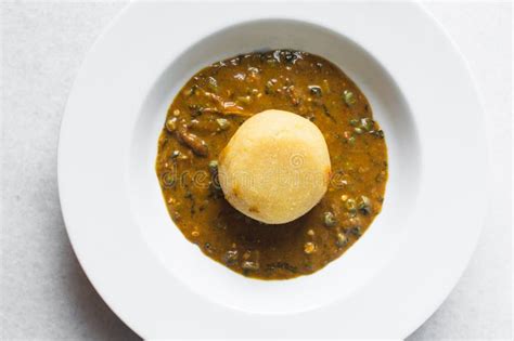 Overhead View Of Nigerian Ogbono Soup And Eba On A White Plate Stock