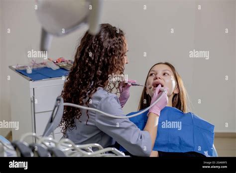 Professional Doctor Dentist Examine And Treat Spoiled Teeth With The