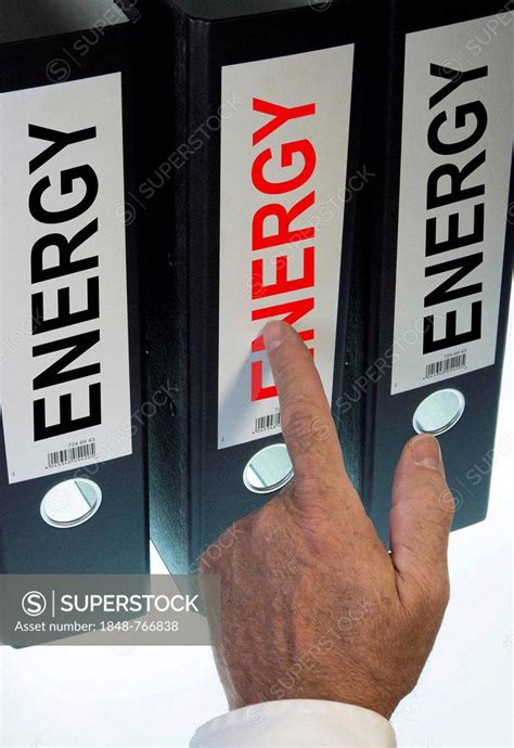 Hand Pointing To A Ring Binder Labeled Energy Symbolic Image SuperStock