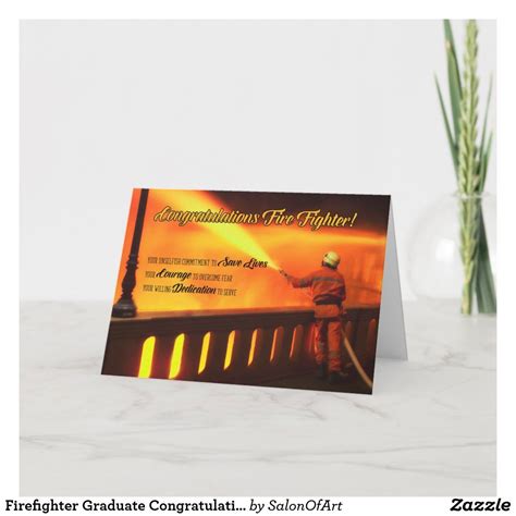 A Card With A Firefighter On It Next To A Vase Filled With Flowers And