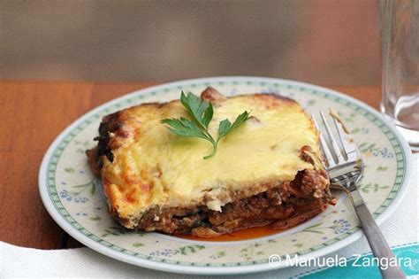 A Piece Of Lasagna On A Plate With A Fork