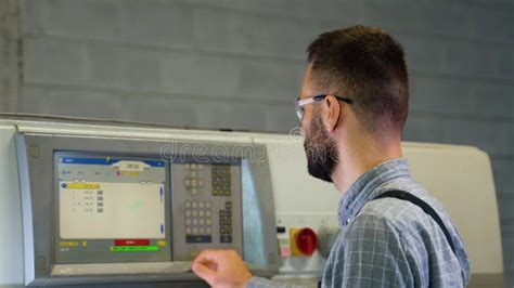 Print House Worker Setting Parameters On Modern Offset Printing Machine