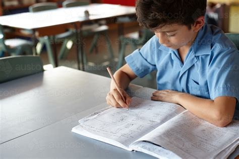 Image Of Young School Boy Doing Maths In Class Austockphoto