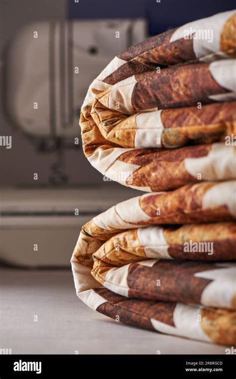 Folded Patchwork Blanket On White Wooden Surface On Sewing Machine