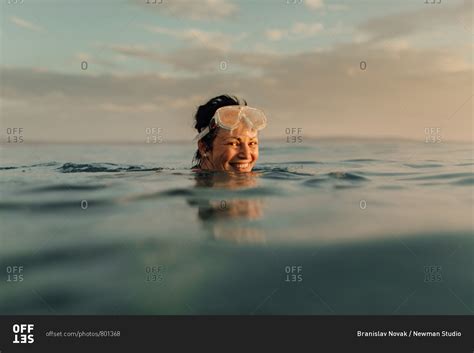 Woman Swimming Alone In Sea At Sunset Woman Wearing Diving Mask At Top