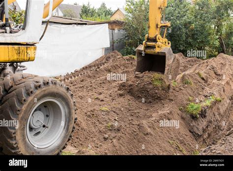 An Excavator Bucket Digs The Ground In An Industrial Area Excavation