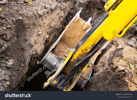 Backhoe Digging A Hole