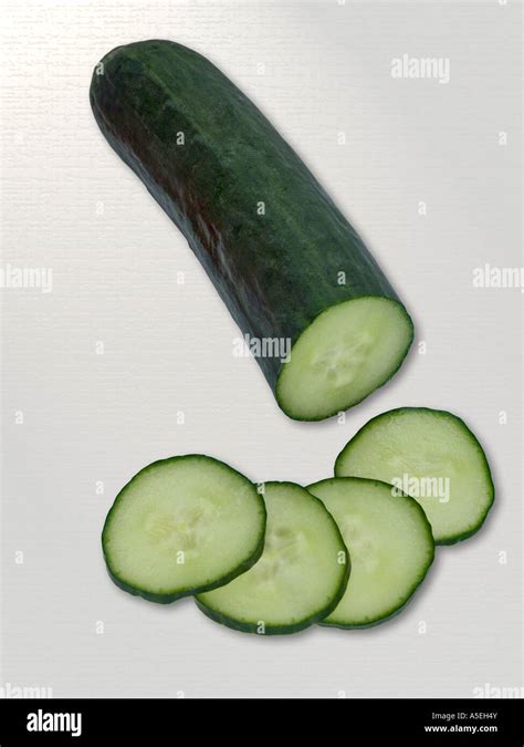 Green Cucumber And Cut Slices On A Light Coloured Background Stock