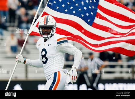 Virginia Wide Receiver Malachi Fields Carries A Flag Onto The Field Before An Ncaa College