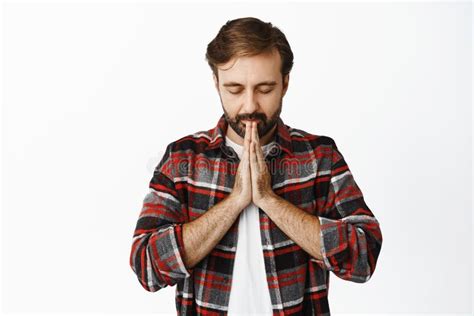 Hopeful Bearded Man Praying Holding Hands In Namaste Pray Gesture And