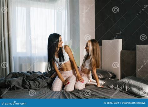 Mom And Teenage Daughter Communicate Sitting On The Bed In The Morning