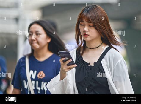 Wuhan A Young Girl Using Her Cellphone At The Exit Of Chuhe Hanije