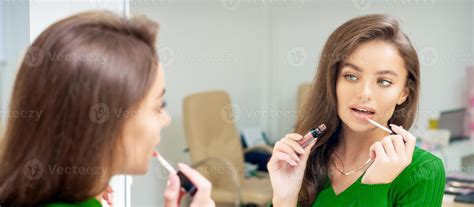 Woman Applying Gloss To The Lips Stock Photo At Vecteezy