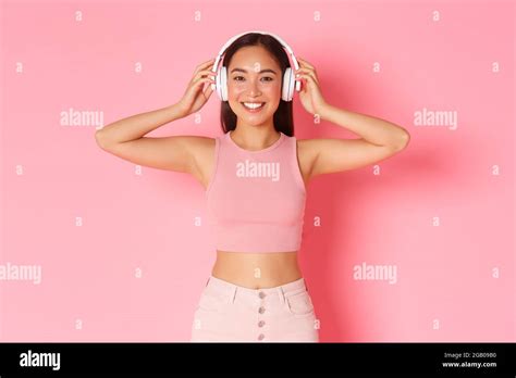 Portrait Of Stylish Good Looking Asian Girl Put On Headphones And