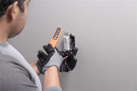 Premium Photo Electrician Man Testing The Electricity Of An Electrical Switch Using A Voltmeter