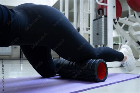 Cropped Shot Of Unrecognizable Slim Sporty Woman Using Foam Roller