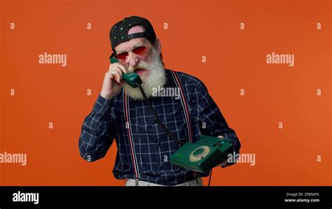 Crazy Elderly Bearded Old Man Talking On Wired Vintage Telephone Of 80s
