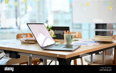 Modern Office Desk With Notebook Laptop Computer Coffee Cup And
