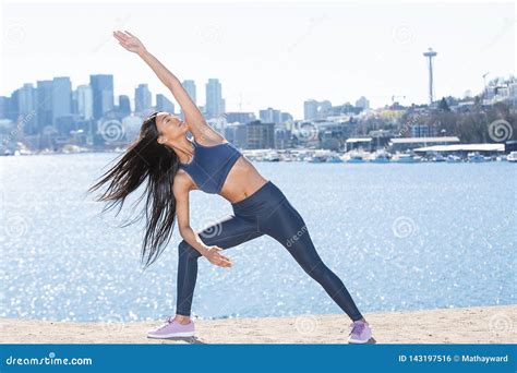 Beautiful Woman With Long Black Hair Wearing Yoga Pants And Sports Bra