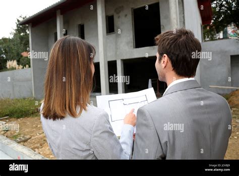 Couple On Construction Site Checking Building Progress Stock Photo Alamy
