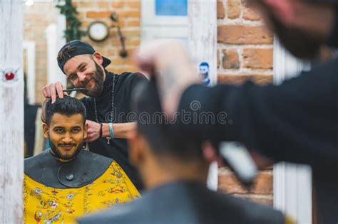 Male Client And His Hair Stylist Reflection In Mirror While Getting A