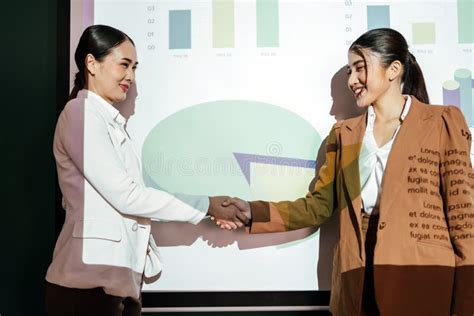 Asian Businesswoman Handshake With Businessman The Teamwork Of