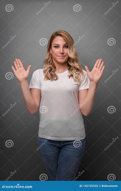 Young Woman Raises Her Hands Up Showing Surprise Or Denial Stock Image