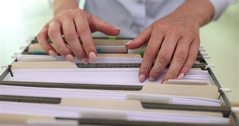 Woman Hands Are Looking In Office For Folders With Necessary Working