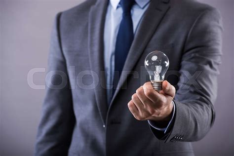 The Businessman Holding Light Bulb In Creativity Concept Stock Image