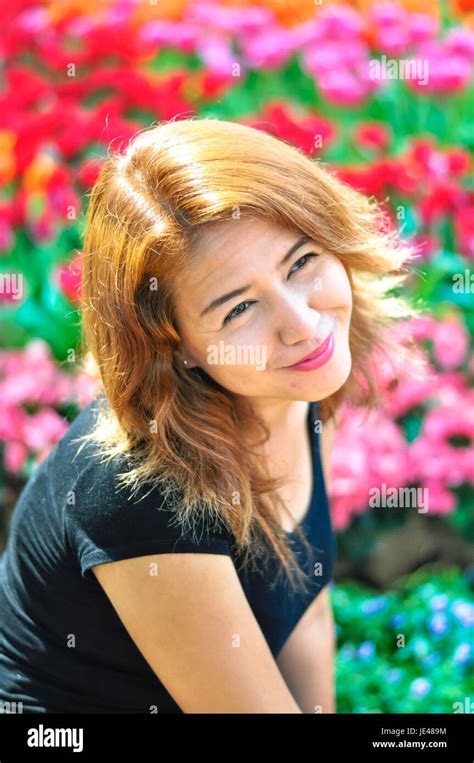 Portrait Of Beauty Smiling Pretty Asian Girl With Beautiful Flowers