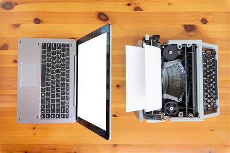 Premium Photo Old Typewriter Vs New Laptop On The Table Concept Of