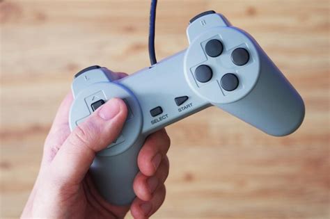 Premium Photo Close Up Of Hand Holding Game Controller