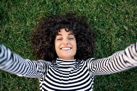 Young Woman Lying On The Grass By Stocksy Contributor Santi Nuñez