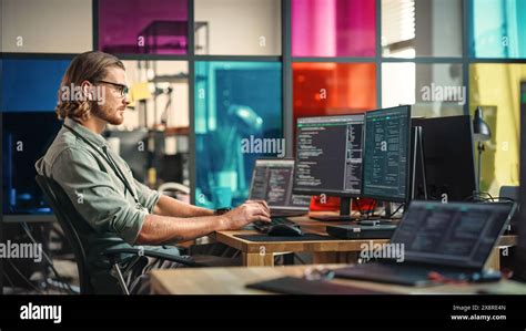 Caucasian Man Writes Code On Desktop Computer With Professional