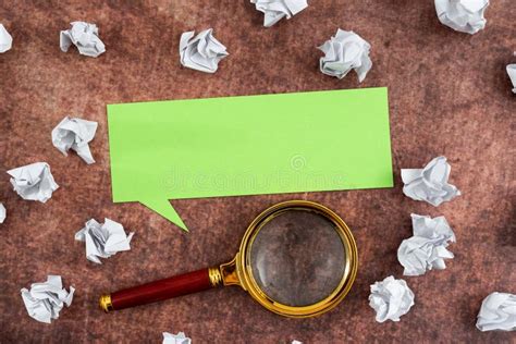Speech Bubble Made Of Sheet With Magnifying Glass Surrounded With